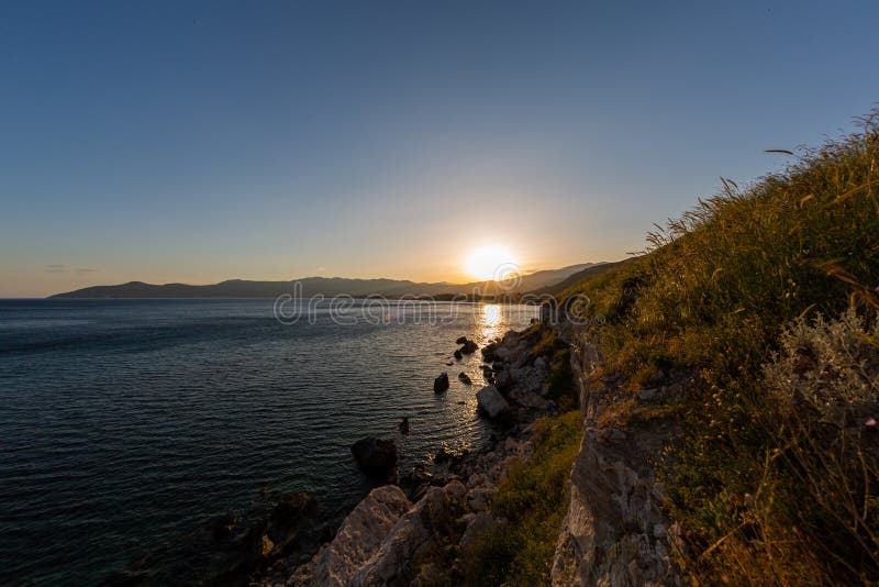Beautiful View of the Sunset Over the Calm Ocean and the Beach Captured ...