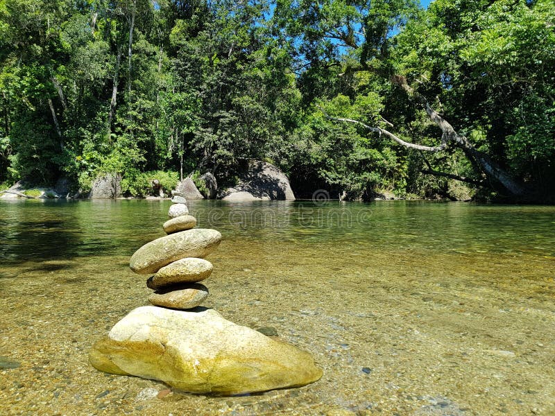 Beautiful View of a Tower of Rocks in the Middle of a Pond Surrounded ...