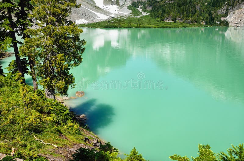 Beautiful View of Trees by an Azure Blanca Lake Surrounded by Cliffs ...