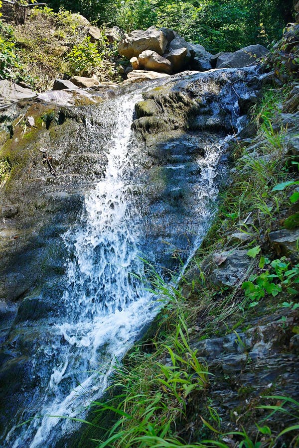 Beautiful Waterfall Breaks Off Cliff in the Forest Stock Photo - Image ...