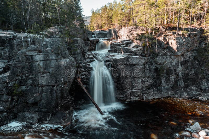 Beautiful Waterfall Cascading Down into a Deep, Lush Gorge, Surrounded ...