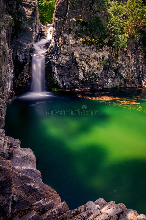 Beautiful Waterfall Falling through Rocks and Forming a Deep Lake on ...