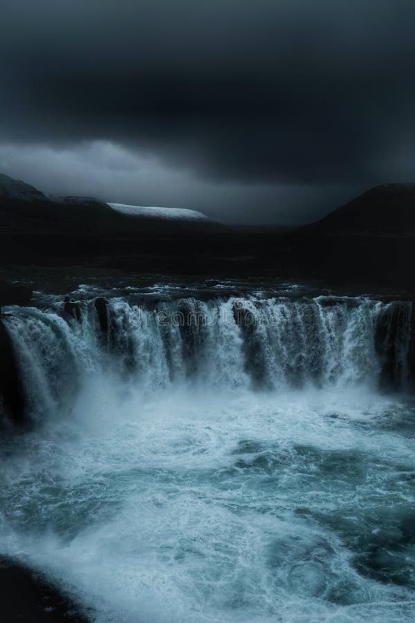 A Beautiful Waterfall in a Field with Dark Sky Stock Photo - Image of ...
