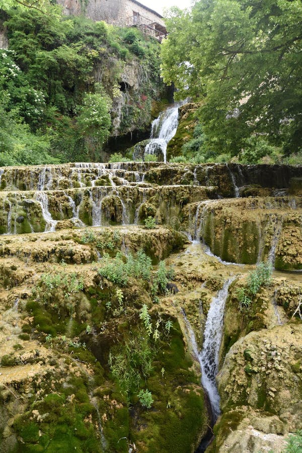 Beautiful Waterfall Flowing Down the Cliffs Surrounded by Greens Stock ...