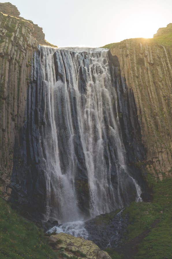 A Beautiful Waterfall in the Mountains. Fresh Water Flows Down from the ...