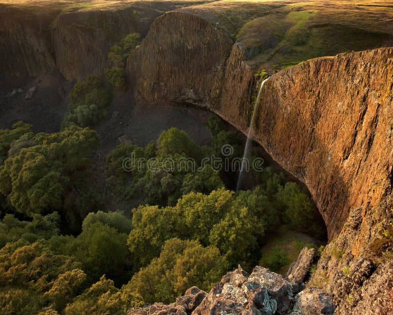 Beautiful Waterfall Over Cliff at Sunset Stock Photo - Image of ...
