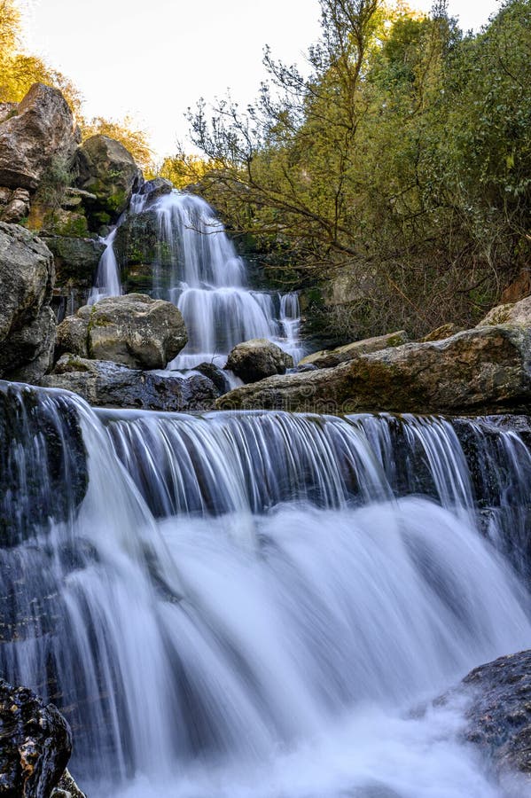 Beautiful Waterfall Flowing in the Middle of a Green Rocky Scenery ...