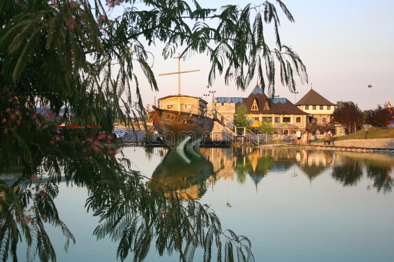 Beautiful Waterfront with a Boat and Charming Buildings during Sunset ...
