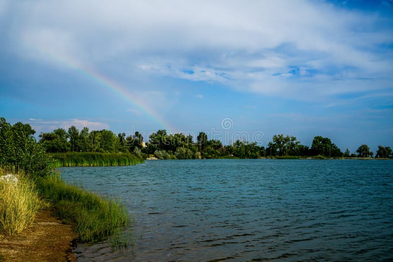Rainbow stock image. Image of clouds, lake, rainbow - 100474789