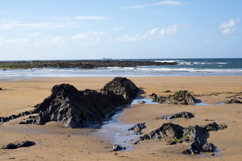 Black rocks gold sand stock photo. Image of water, break - 2191552