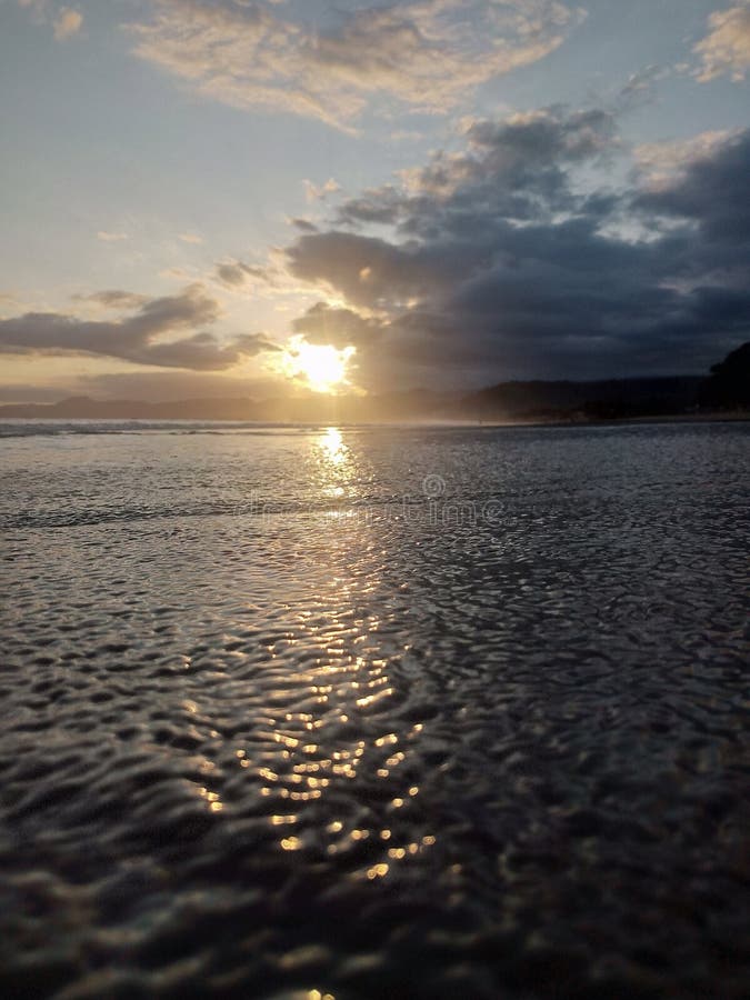 Beautiful Waves Ripple at Sunset with Cloudy Sky? Stock Image - Image ...