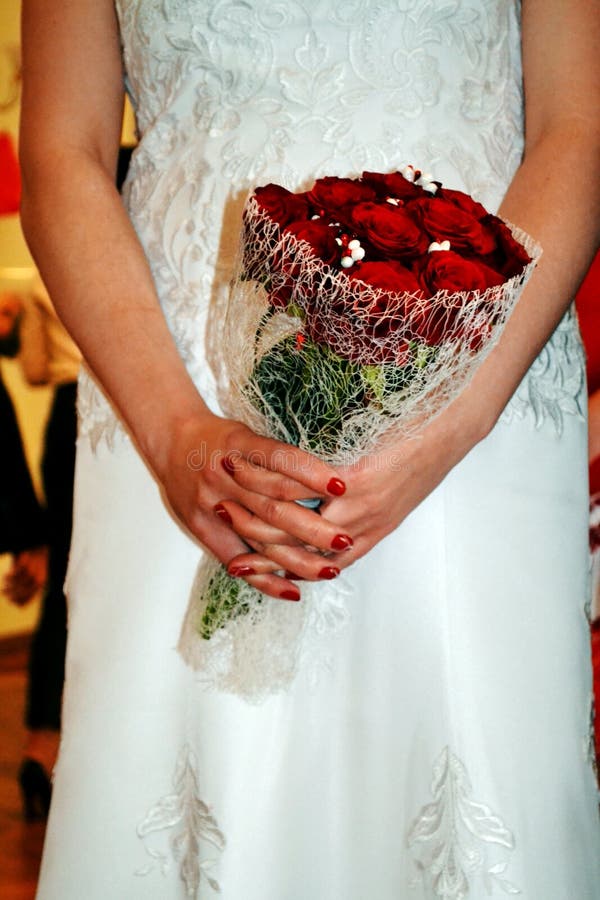 Beautiful Wedding Bouquet of Red Roses in the Hands of the Bride Stock ...