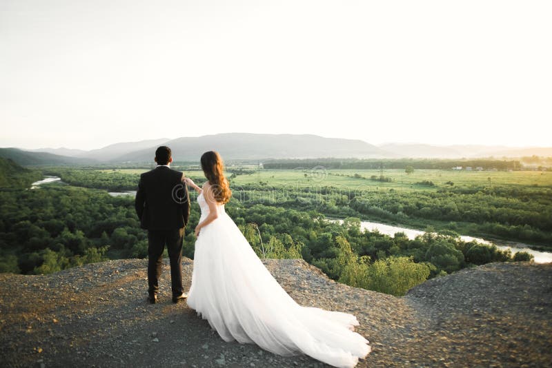 Beautiful Wedding Couple Staying Over Beautiful Landscape Stock Photo ...