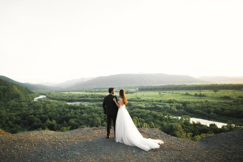 Wedding Couple in Love Kissing and Hugging Near Rocks on Beautiful ...