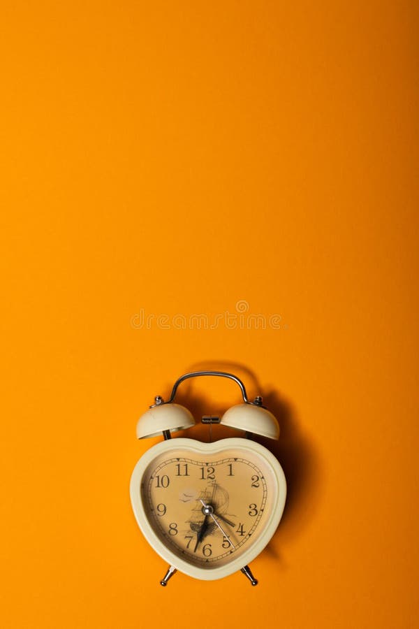 A Beautiful White Clock in the Shape of a Heart on a Yellow Background ...