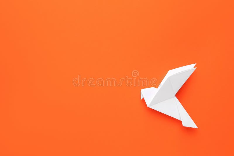 Beautiful White Origami Bird on Orange Background, Top View. Space for ...