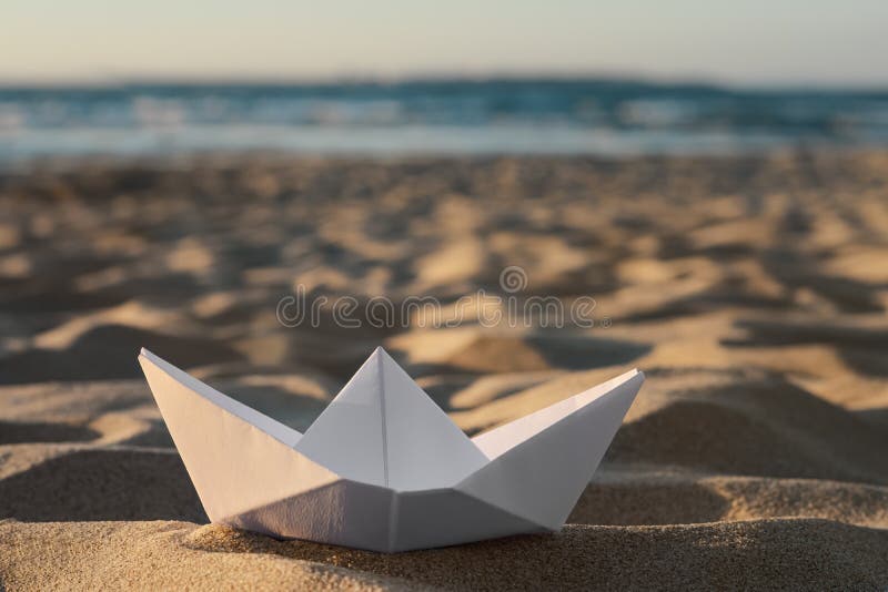 Beautiful White Paper Boat on Sand Outdoors, Closeup Stock Photo ...