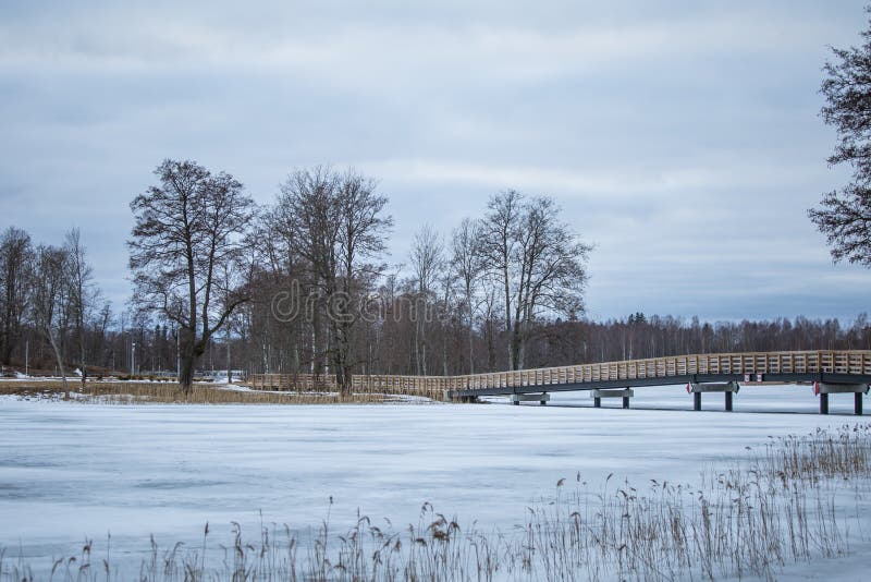 A Beautiful Winter Landscape with a Bridge Over the Frozen River Stock ...