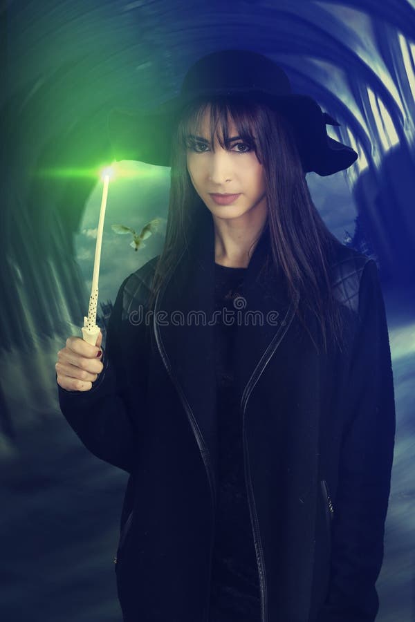 Beautiful Witch Holding a Magic Wand Stock Photo - Image of light ...