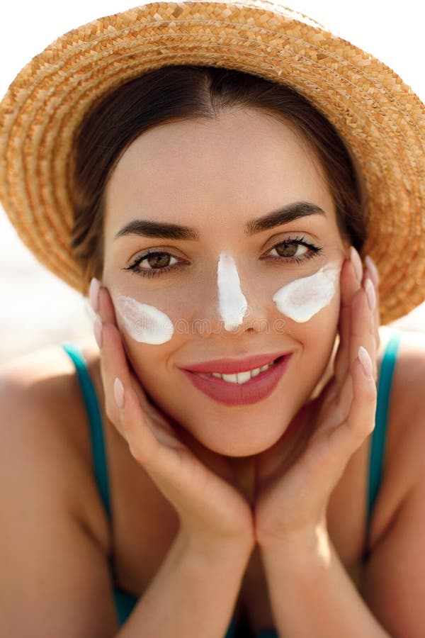 Beautiful Woman Applying Cream Sunscreen On A Tanned Face Sunscreen