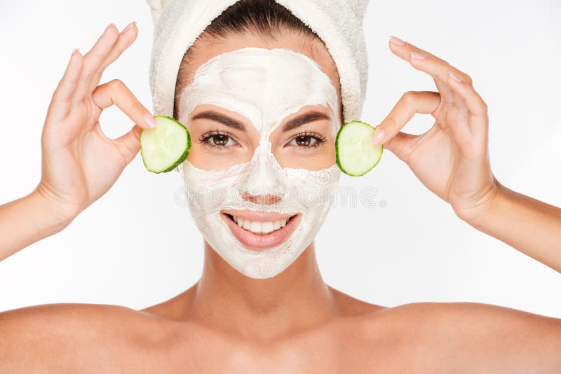 Beautiful Woman Applying Cucumber On Her Face With Cosmetic Mask Stock
