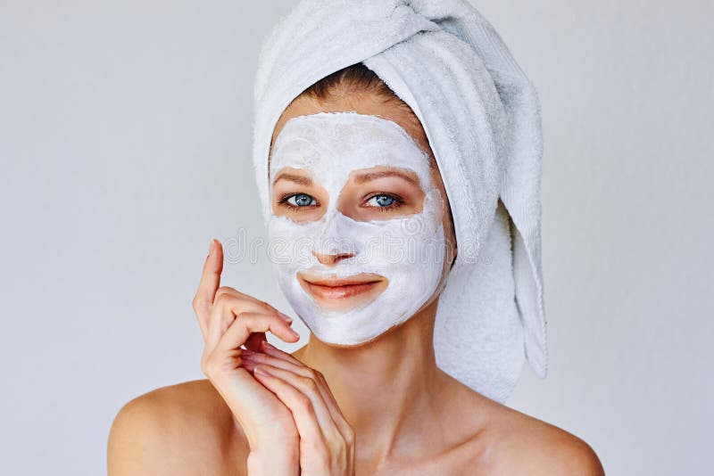 Beautiful Woman Applying Facial Mask On Her Face Skin Care And