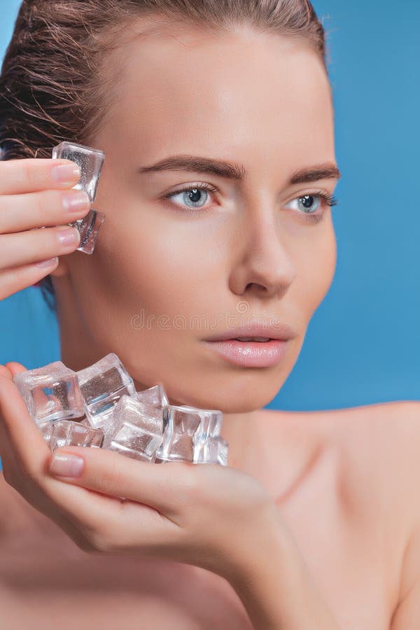 Beautiful Woman Applying Ice Cube Treatment on Blue Background Stock ...