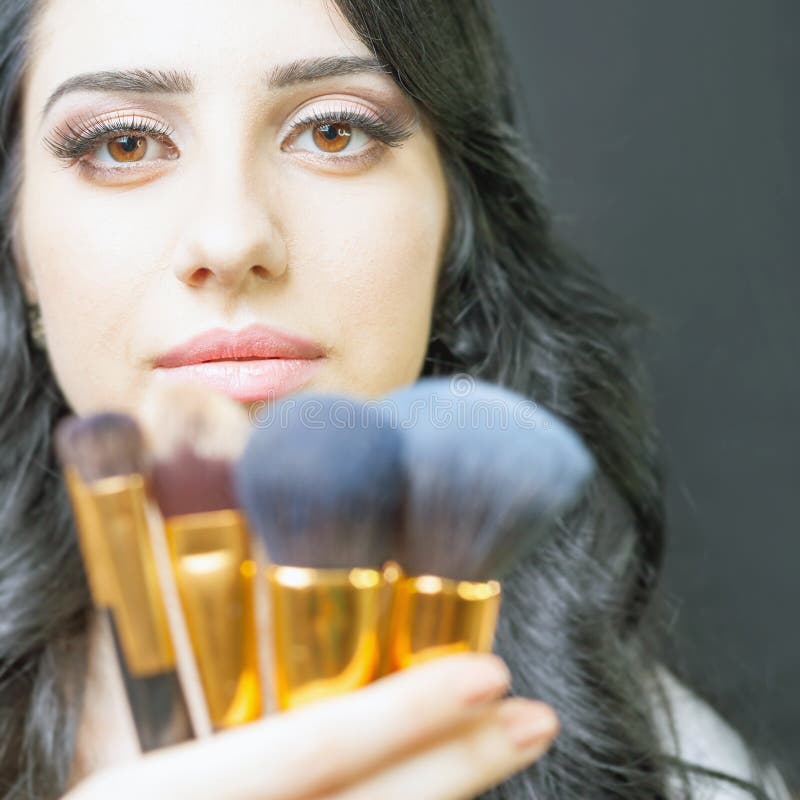Beautiful Woman At Beauty Salon With Set Of Makeup Brushes Stock Image