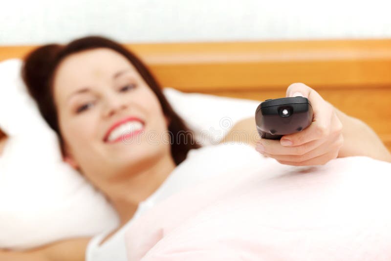 Beautiful Woman in Bed Holding a Remote Control. Stock Photo - Image of ...