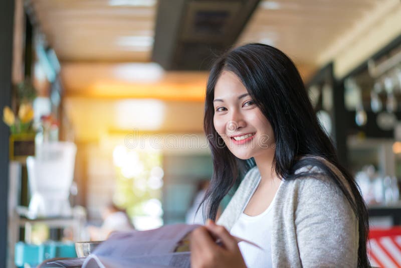 Beautiful Woman in Coffee Cafe Reading a Book with Relaxing Stock Image ...