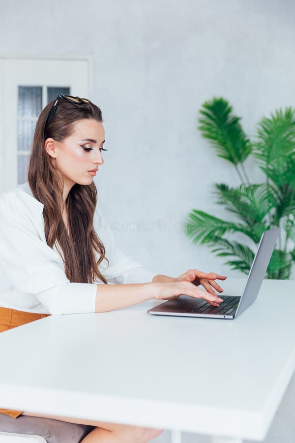 Beautiful Young Woman at Computer in Office Stock Image - Image of ...