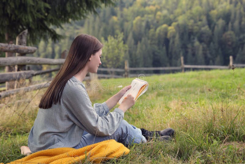 Beautiful Young Woman Drawing with Pencil in Notepad on Green Grass ...