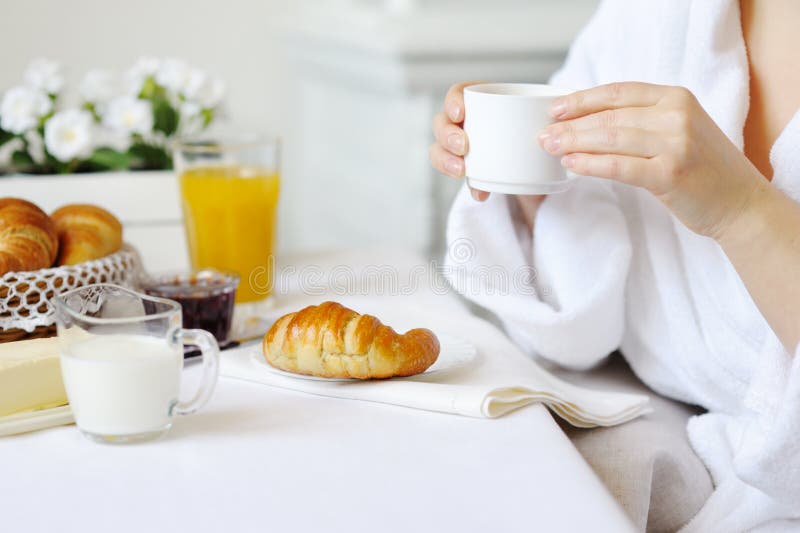 Beautiful Woman Drinking Hot Drink at the Table. with a Croissant Stock ...