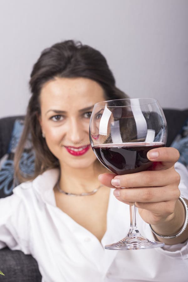 Beautiful Woman Drinking Wine Sitting on a Sofa Stock Photo - Image of ...