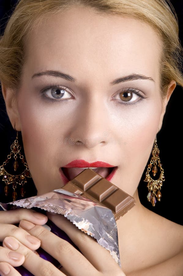 Beautiful Woman Eating Chocolate Stock Photo - Image of hold, block ...