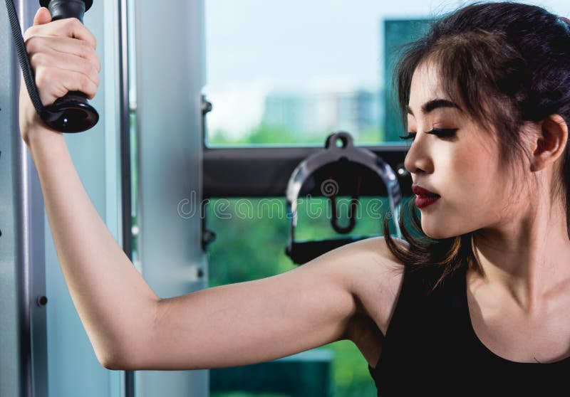 Beautiful Woman Exercise Using Machine Crossover Cable Training Workout ...