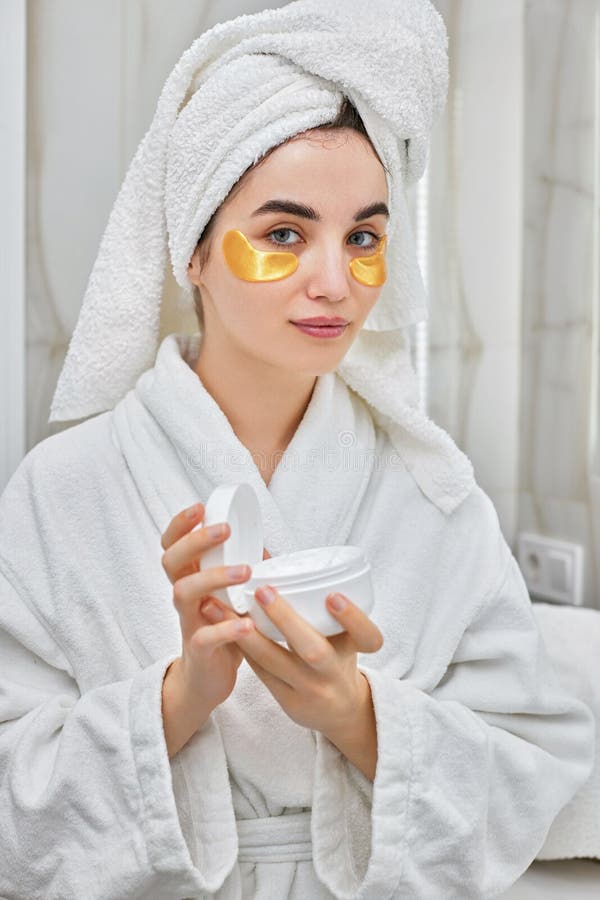 Beautiful Woman With Eye Patches In White Bathrobes In Bathroom Stock