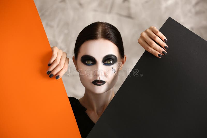 Beautiful Woman with Halloween Makeup and Posters on Grey Background ... Beautiful Woman with Halloween Makeup and Posters on Grey Background ...