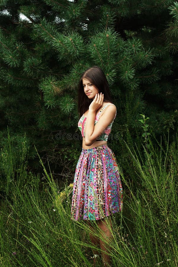 Beautiful Woman Hipster Posing And Holding Rustic Bouquet In Grass