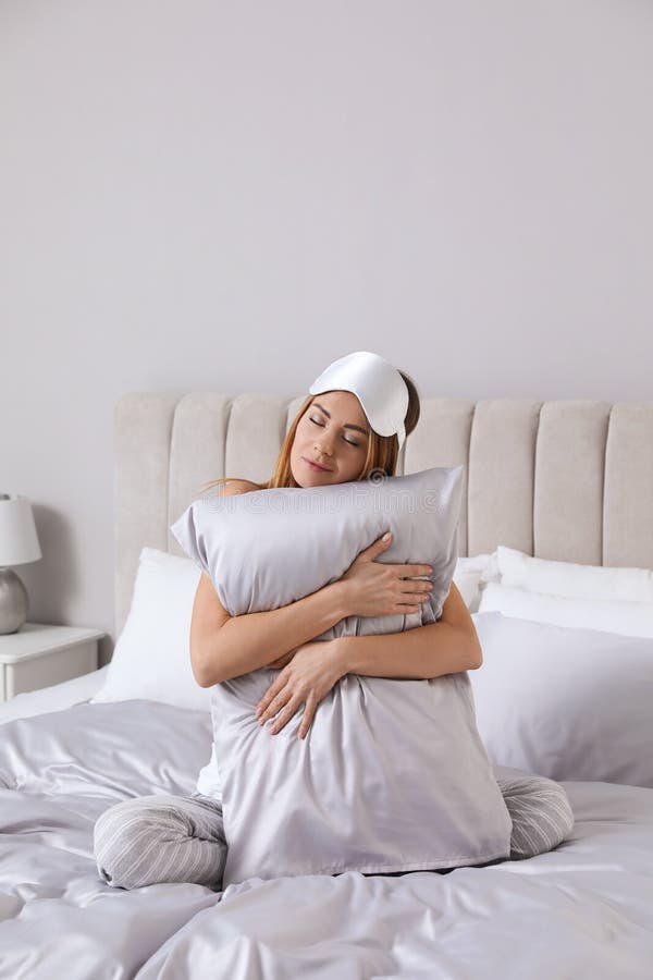 Beautiful Woman Hugging Pillow on Comfortable Bed with Silky Linens ...