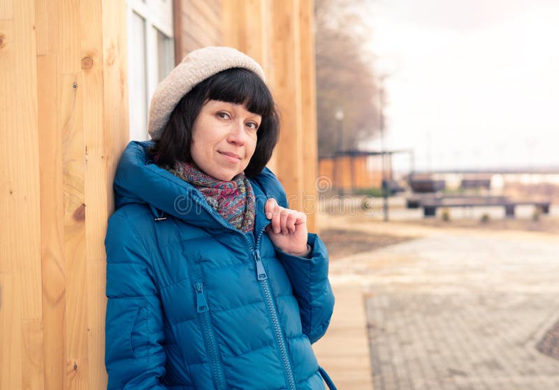 A Beautiful Woman in a Jacket Walks in a Spring Park by the River Stock ...