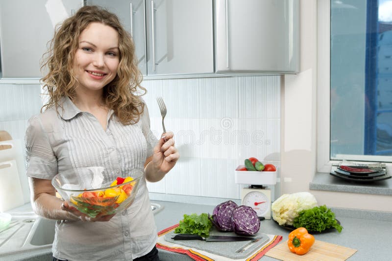 Beautiful woman in kitchen stock image. Image of eating - 13035493