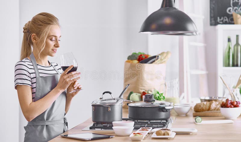 Beautiful Woman in Kitchen is Drinking Red Wine Stock Image - Image of ...