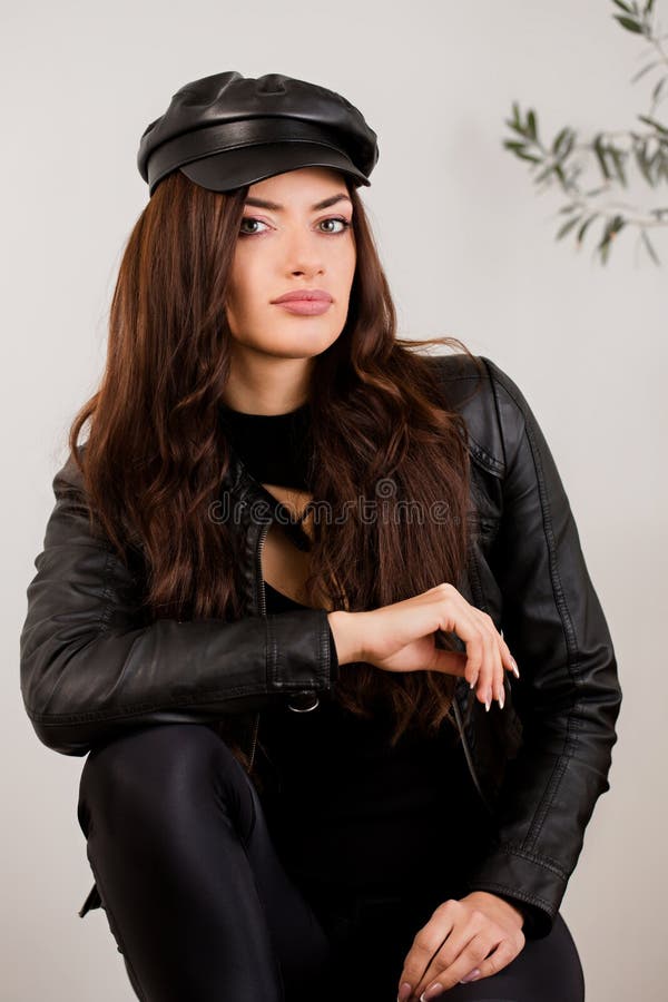 Beautiful Woman in a Leather Jacket and Cap Stock Image - Image of ...
