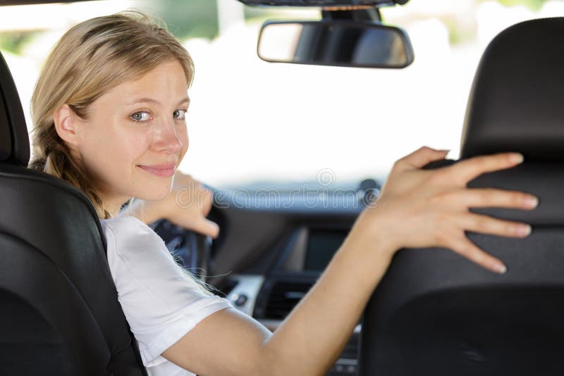 Beautiful Woman Looking Back while Driving Car Stock Image - Image of ...