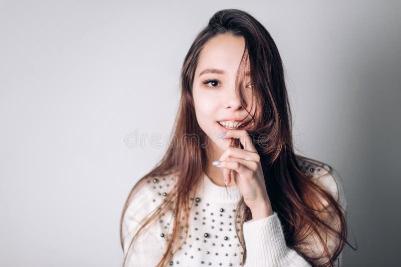 A Beautiful Woman Looks Cunning at the Camera with a Snide Smile ...