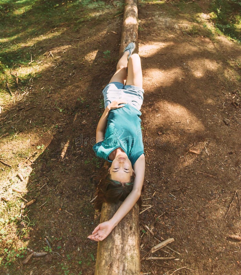 Beautiful Woman Lying on Fallen Tree Trunk, Looking at Camera. Stock ...