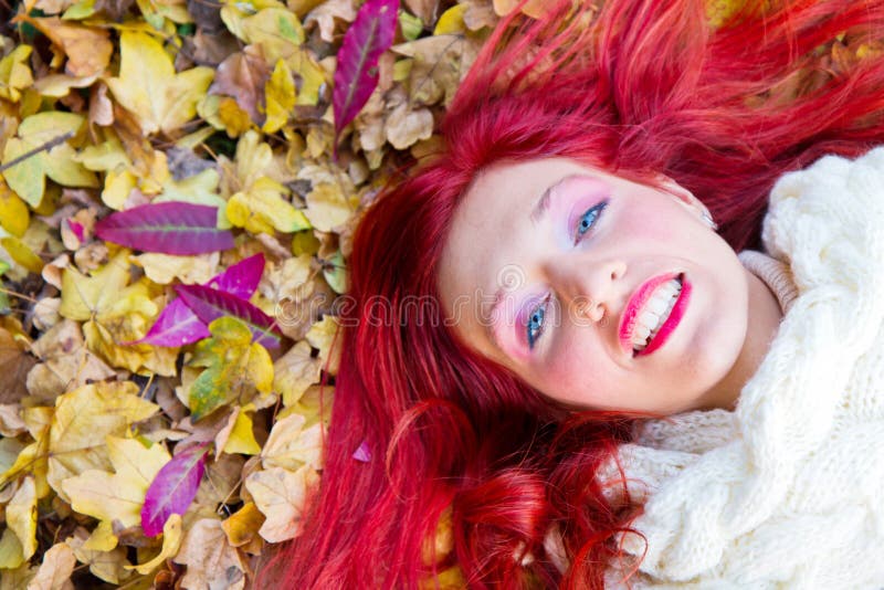 A Beautiful Woman Lying on Red Autumn Leaf Stock Photo - Image of ...