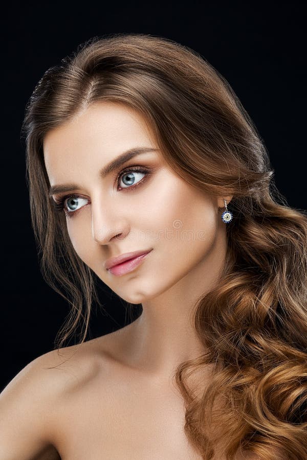 Beautiful Woman With Make Up And Hairstyle Over Black Background Stock