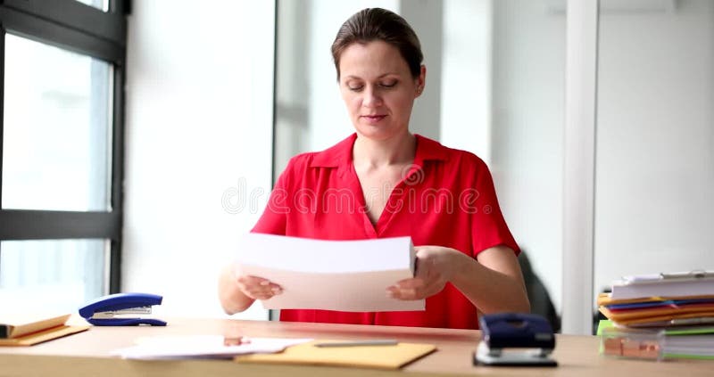 Beautiful Woman in the Office Holding a Stack of White Sheets of Paper ...